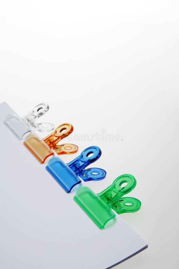 Four Paper Clips Clipping the Same Stack of Papers Stock Photo - Image ...