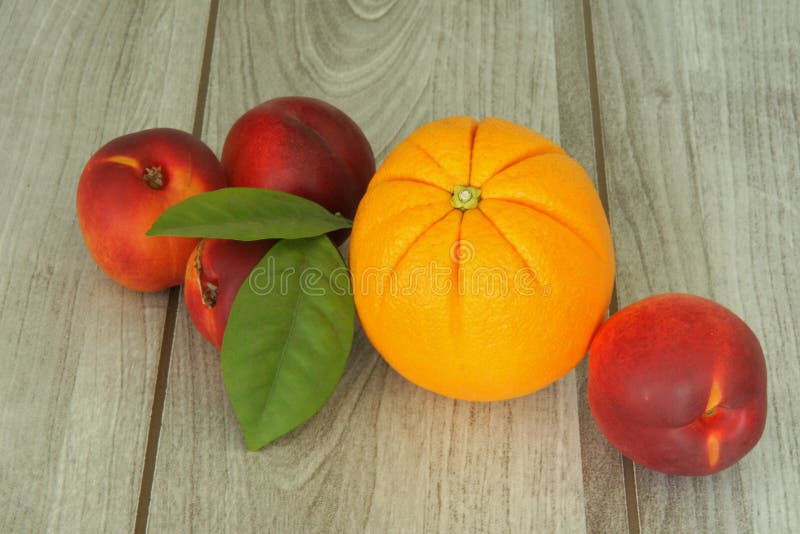Four Peaches and an Orange with an Unusual Texture. Stock Photo - Image ...
