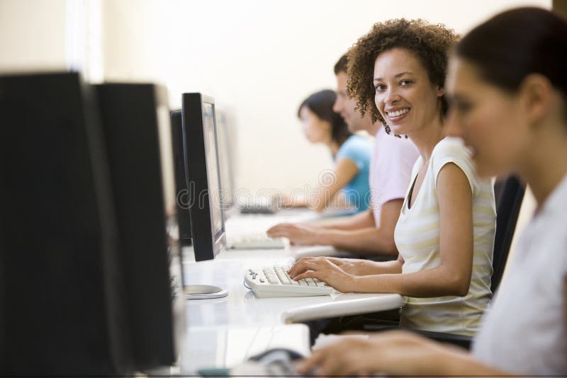 Four People in Computer Room Typing and Smiling Stock Image - Image of ...