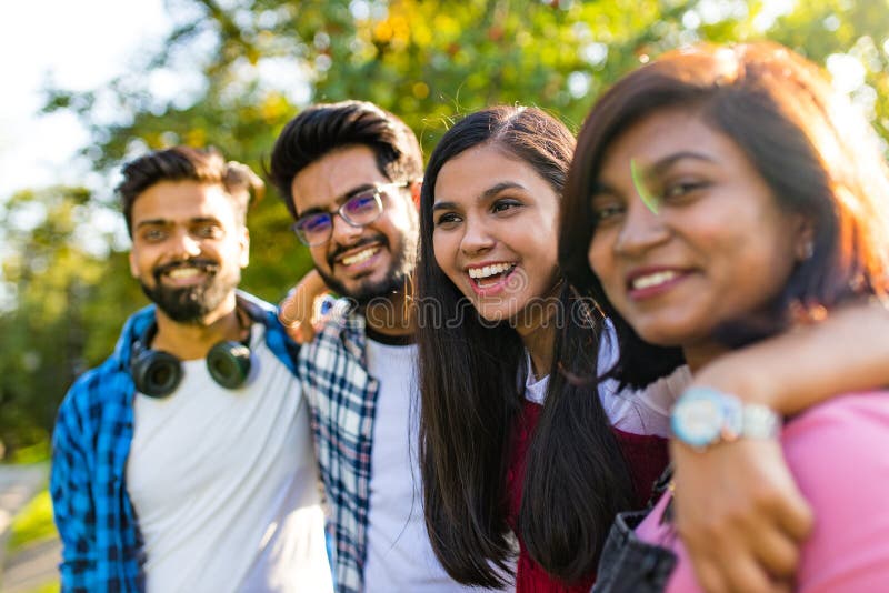 Four People Having Fun Outdoors, Focus on Beautiful Indian Woman Stock ...