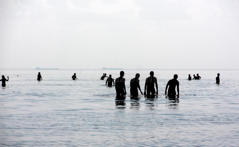 Four people in the sea stock photo. Image of backlight - 42002392
