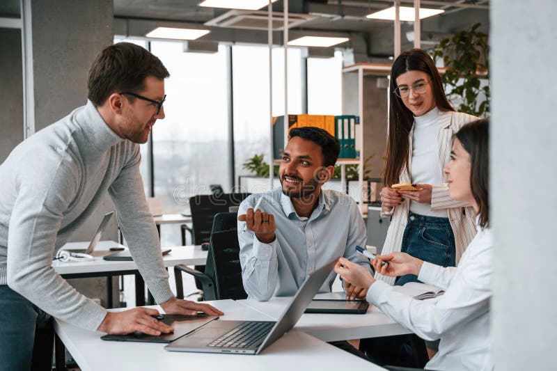 Four People are Working in the Office Together Stock Photo - Image of ...