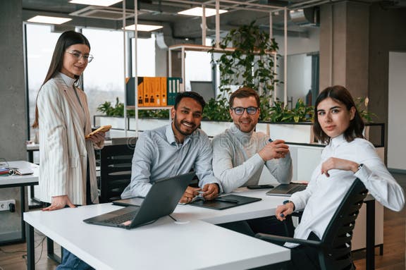 Four People are Working in the Office Together Stock Photo - Image of ...