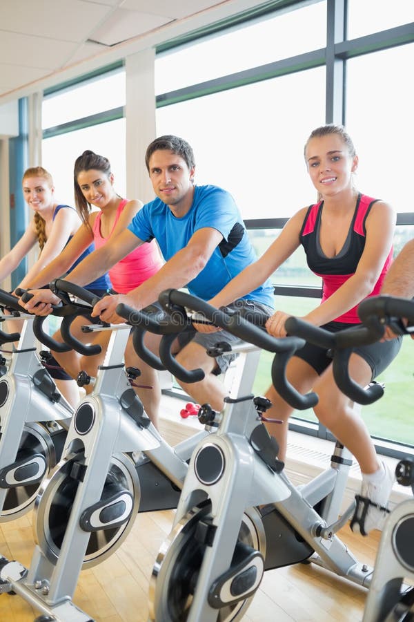 Four People Working Out at Spinning Class Stock Image - Image of ...