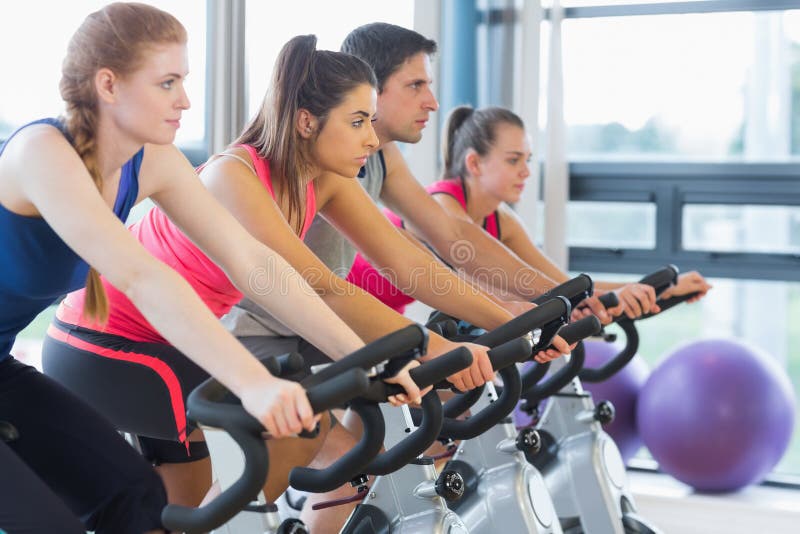 Four People Working Out at Spinning Class Stock Photo - Image of ...