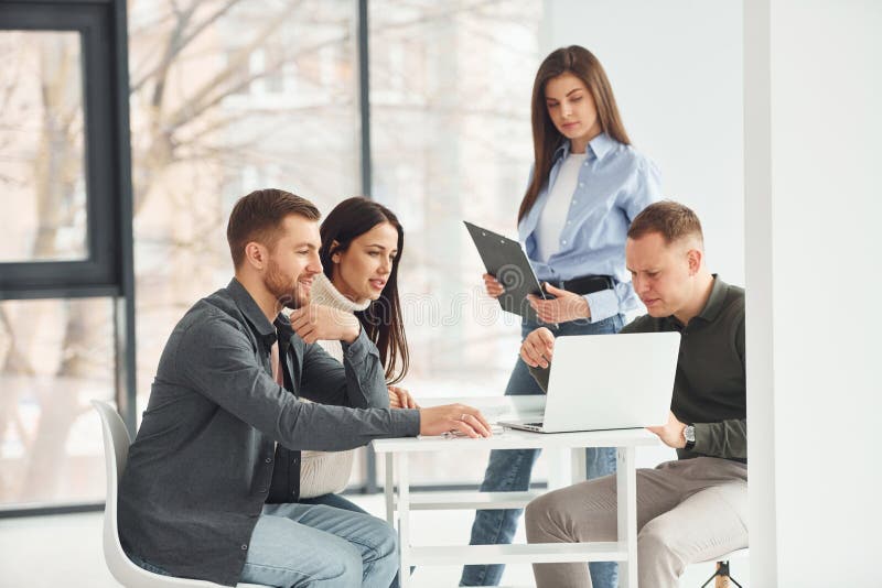Four People Works in the Office by Sitting by the Table Indoors Stock ...