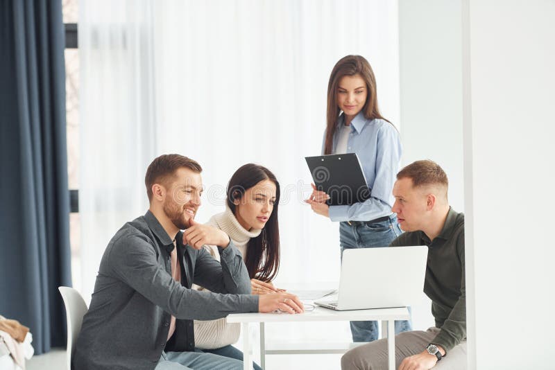 Four People Works in the Office by Sitting by the Table Indoors Stock ...