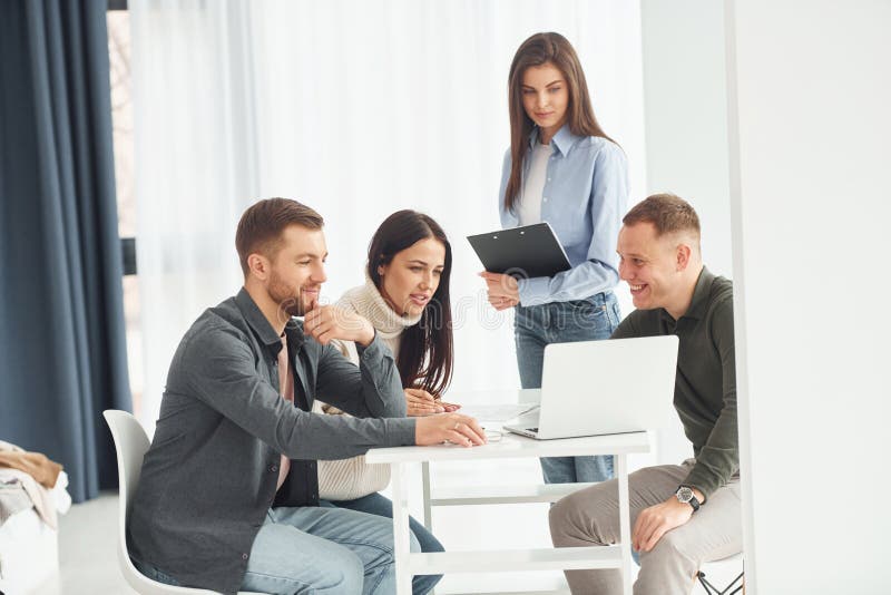 Four People Works in the Office by Sitting by the Table Indoors Stock ...