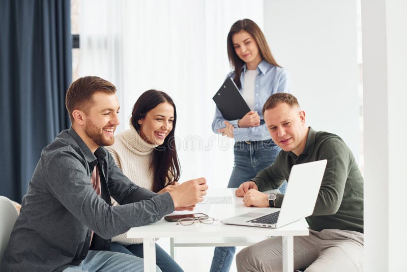 Four People Works in the Office by Sitting by the Table Indoors Stock ...