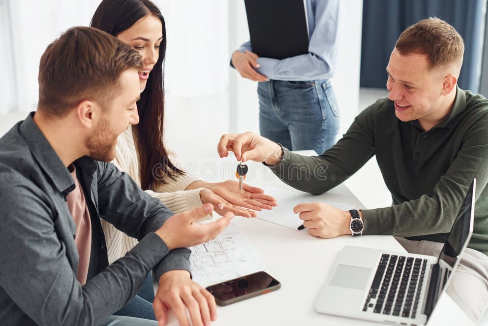 Four People Works in the Office by Sitting by the Table Indoors Stock ...