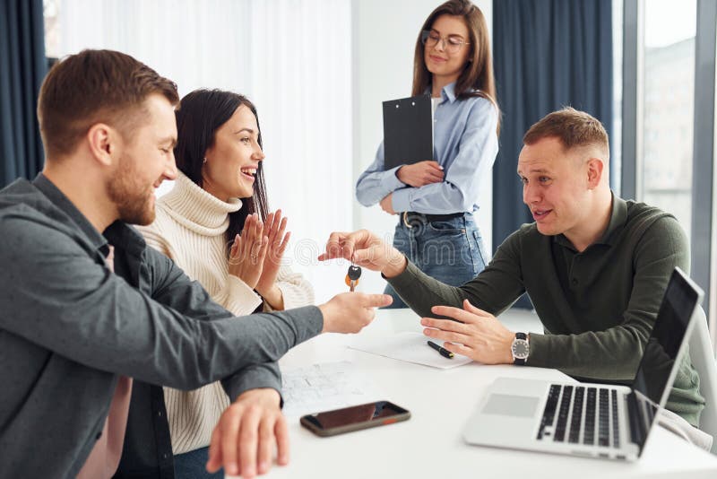 Four People Works in the Office by Sitting by the Table Indoors Stock ...