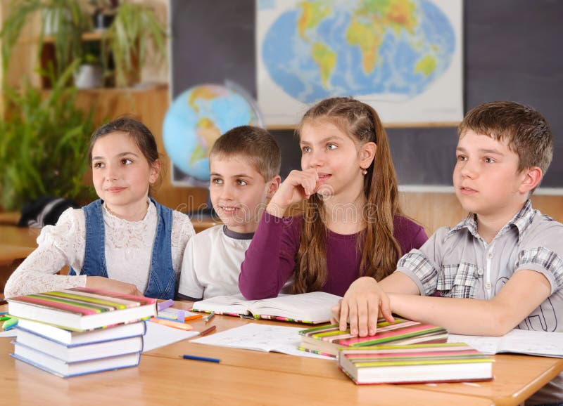 Four pupils in classroom stock photo. Image of classmate - 27170684