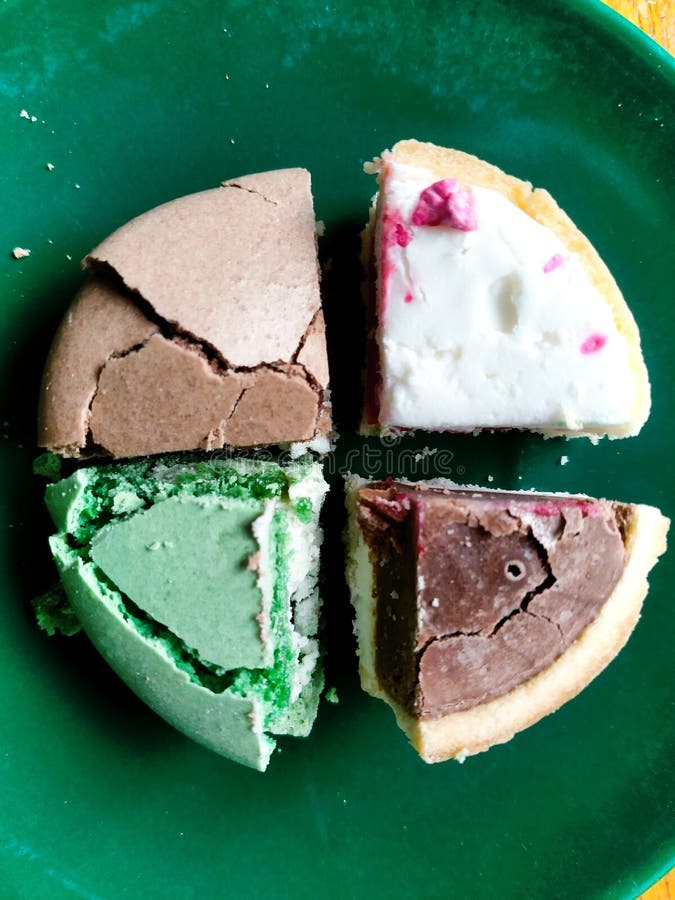 Four Quarters of Different Cakes on a Green Plate Stock Image - Image ...