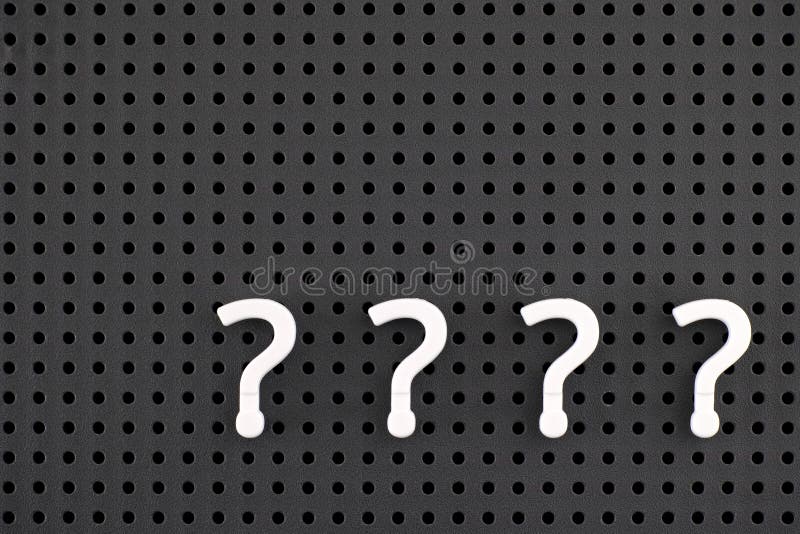 Four Question Marks Spelled Out by White Symbols on Gray Pegboard Stock ...