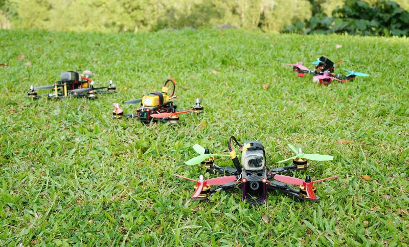 Four Racing Drone on Green Field Stock Photo - Image of propellers ...