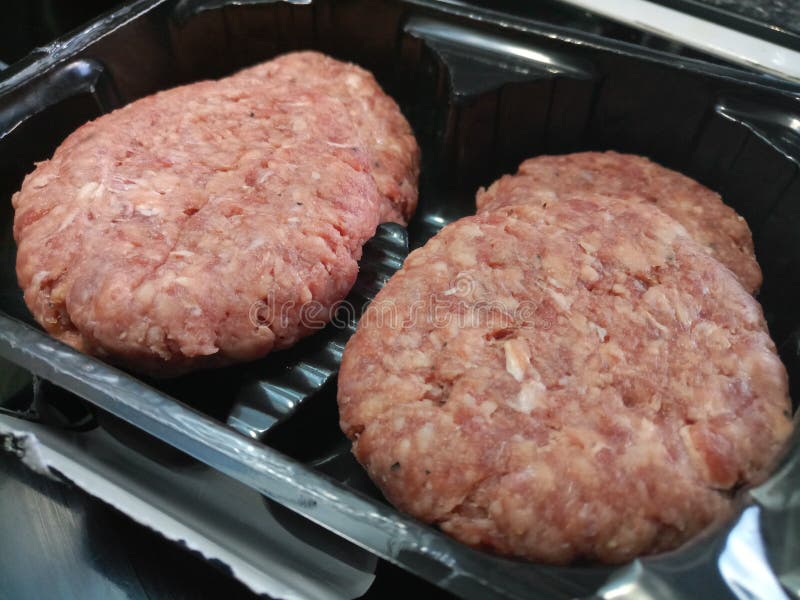 Four Raw Organic Beef Burgers in a Plastic Packaging Stock Photo ...