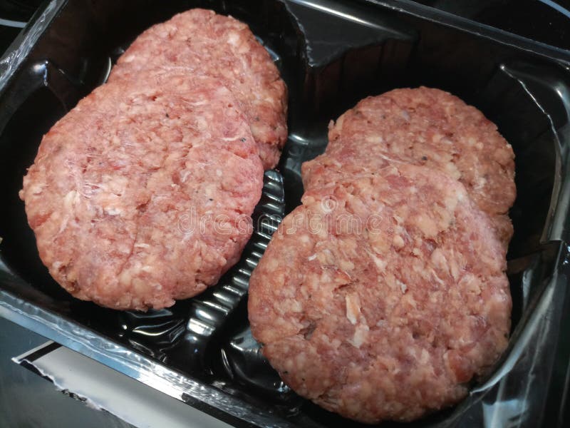 Four Raw Organic Beef Burgers in a Plastic Packaging Stock Photo ...