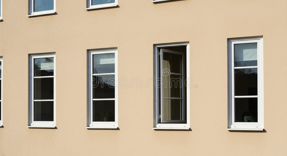 Four Rectangular Windows with White Frames are Evenly Spaced on a Beige ...