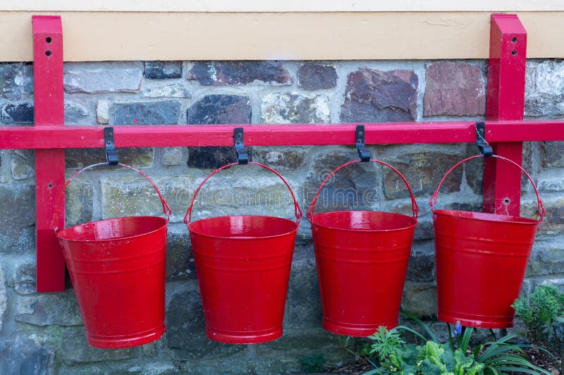 Four Red Buckets Hanging on a Wall. Backgound Maybe. Stock Image ...