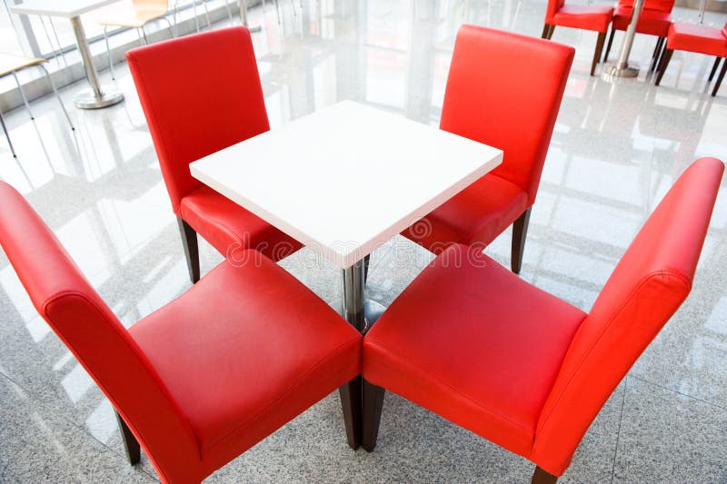 Four red chairs at a table stock image. Image of business - 15997227