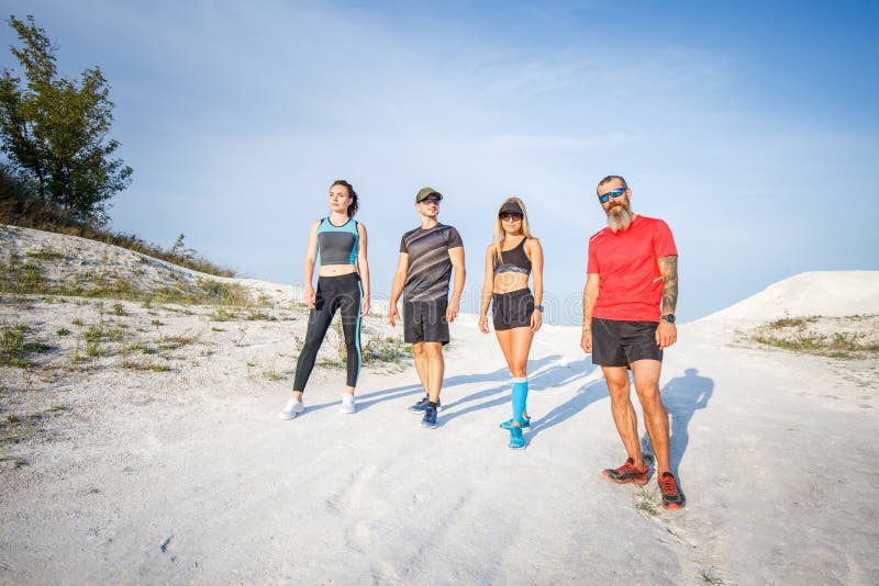 Four Runners Training in a Group on a Red Track in Winter Stock Photo ...
