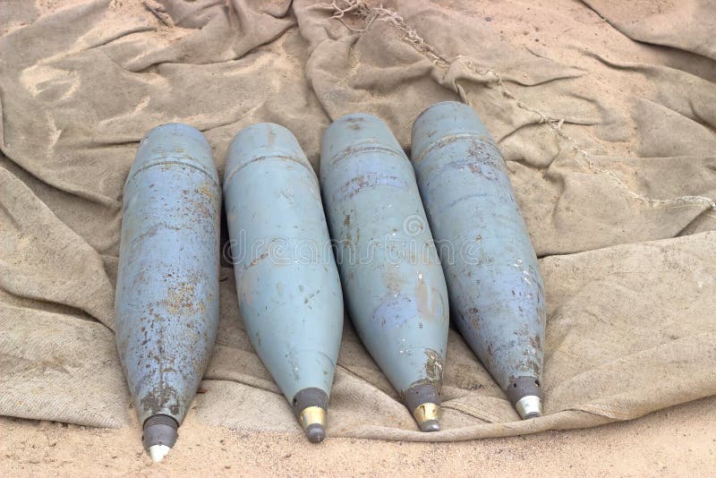 Four Rusty Artillery Shells on Sand Stock Image - Image of cannonball ...