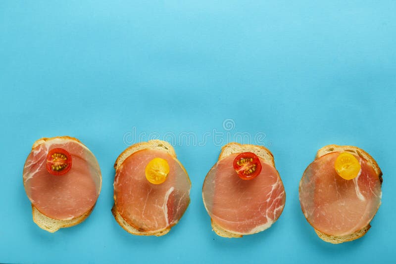 Four Sandwiches with Ham on a Blue Background. Copy Place Stock Photo ...