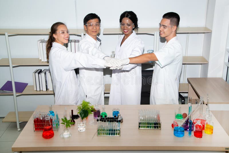 Four Scientists Wore a White Robe, Smiled, and Stood To Show that the ...