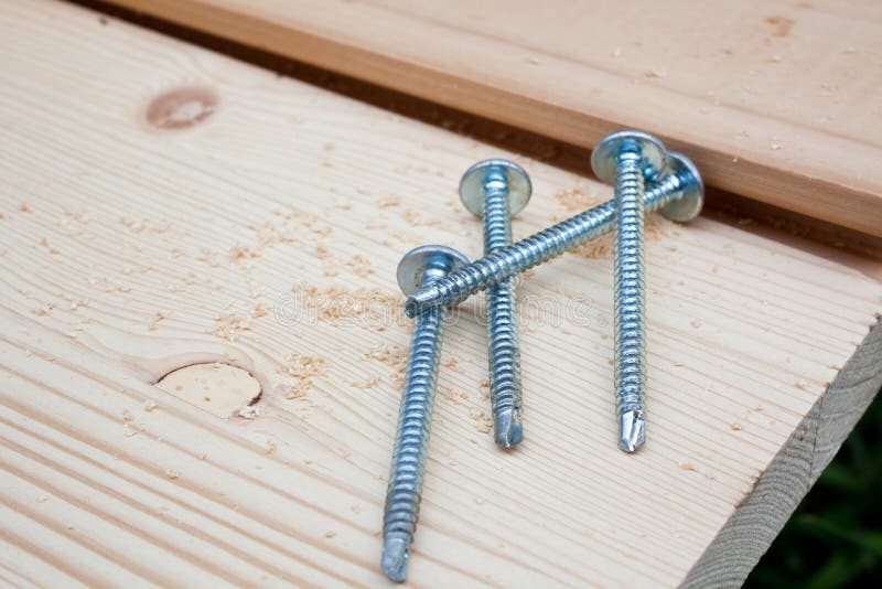 Four screws on wood plank stock photo. Image of softwood - 14564202