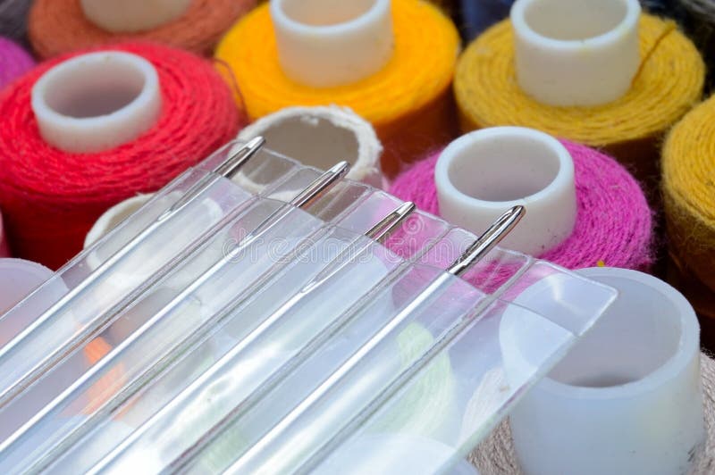 Four Sewing Needles on a Background of Spools of Thread. Close-up Stock ...