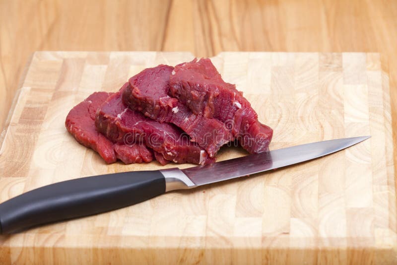 Four Slice Beef Tenderloin on Cutting Board Stock Photo - Image of beef ...