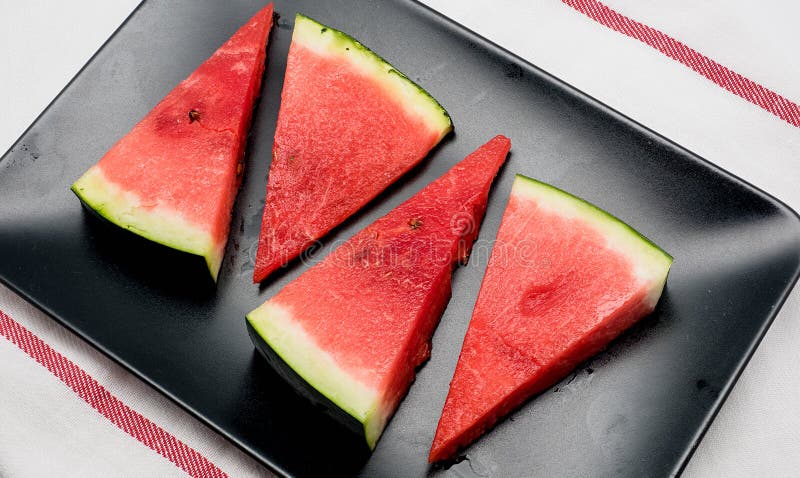 Four Slices of Watermelon on Black Dish Stock Image - Image of studio ...