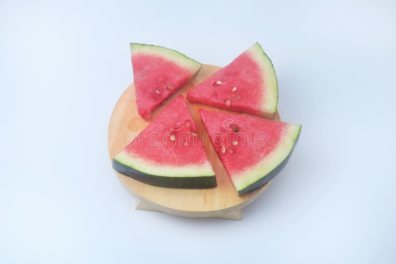 Four Slices of Watermelon are on a Wooden Base and White Background ...