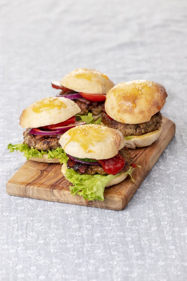 Four small hamburgers stock photo. Image of four, lunch - 180971168