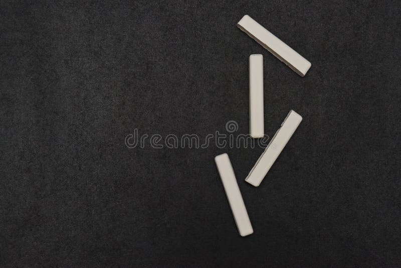 Four Small White Chalk on a Blackboard Background Stock Image - Image ...