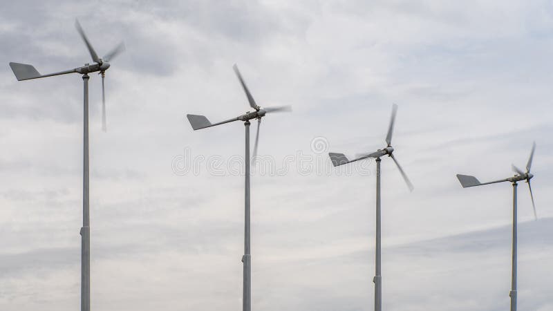 Four Small Wind Turbines in the Background of Clouds. Environmentally ...