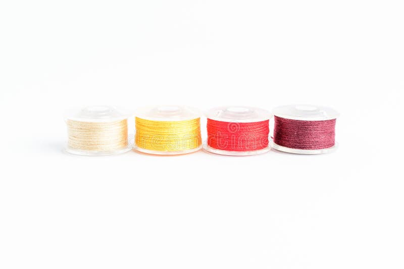 Four Spools of Beige, Yellow, Red and Burgundy Threads Prepared for the ...
