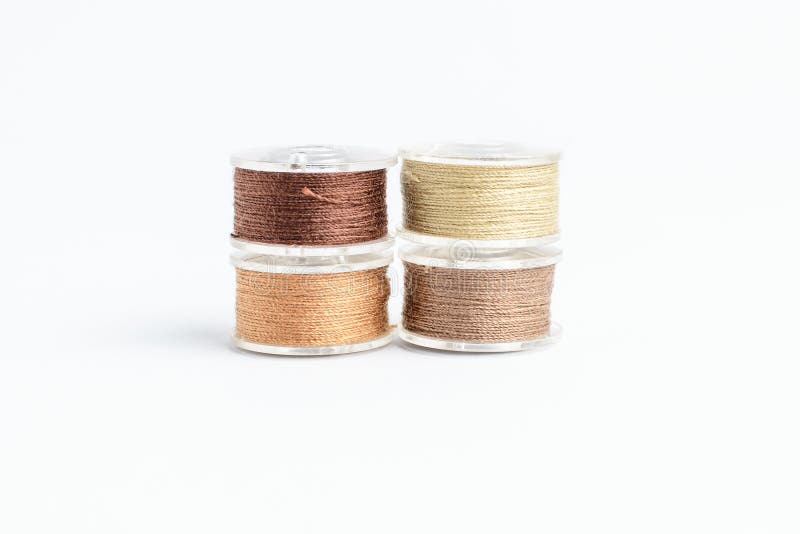 Four Spools of Brown and Beige Mixed Threads Prepared for the Sewing ...