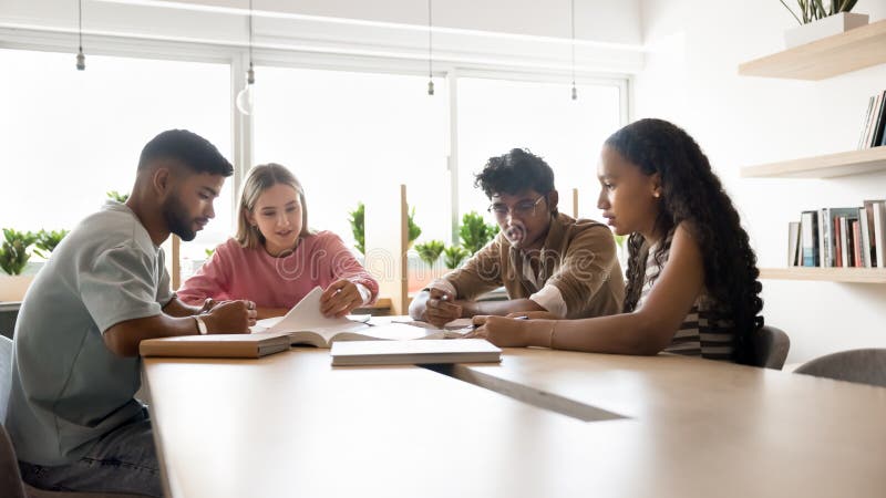 Four Students Gathered Around Table in Modern Study Space Stock Image ...