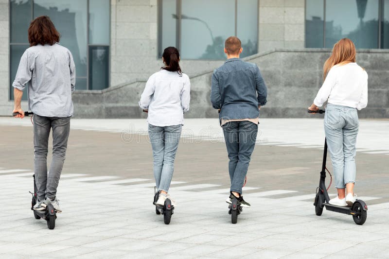 Four Students Having Ride Motorized Kick Scooters Stock Photos - Free ...