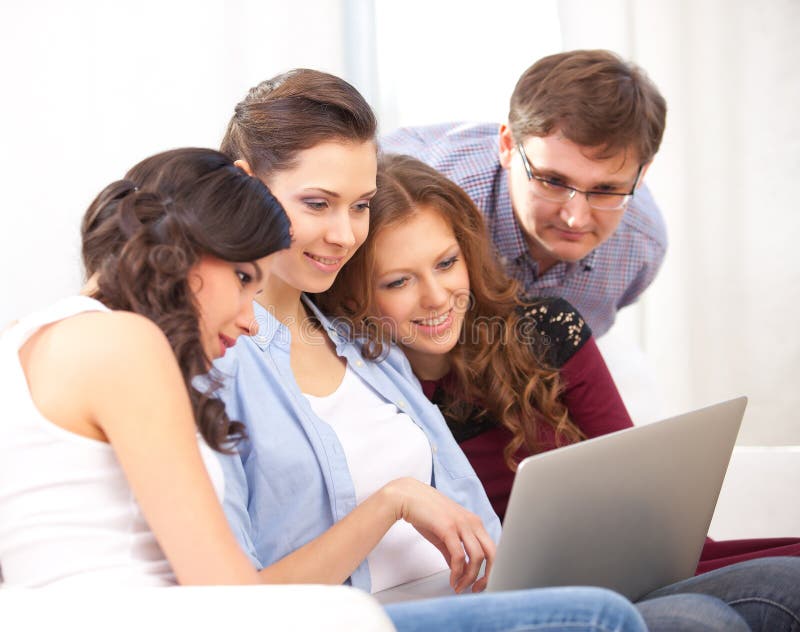Four students and a laptop stock photo. Image of smile - 43792062