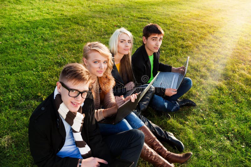 Four students with laptop stock photo. Image of brunet - 29947920