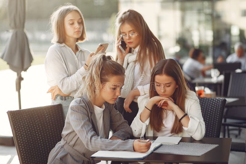 Four Students on a Student Campus Sitting at the Table Stock Photo ...