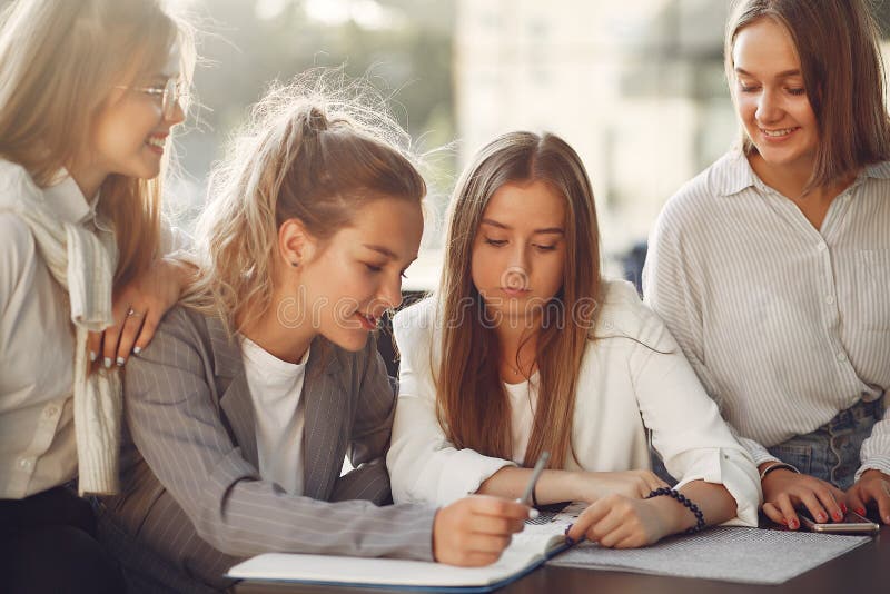 Four Students on a Student Campus Sitting at the Table Stock Image ...