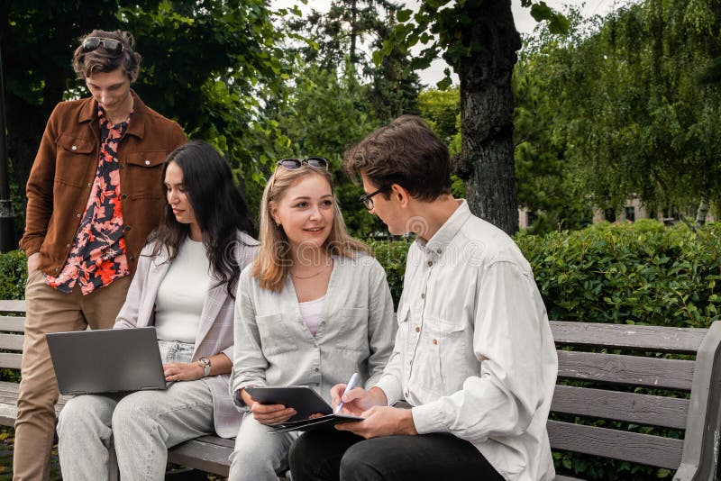 Four Students with Studying in Park with Laptop and Tablet Stock Image ...