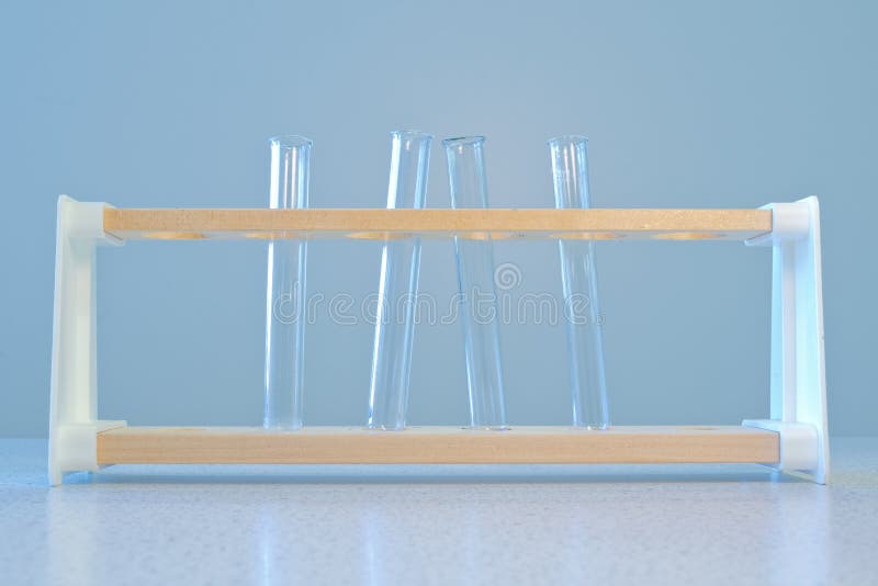 Four Test Tubes with Red, Yellow and Blue Liquid on a White Background ...