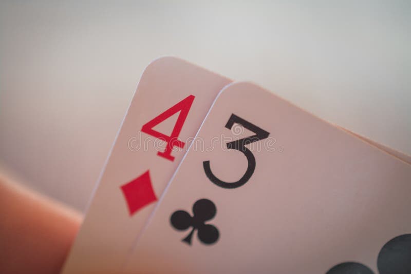 Four and Three, Playing Cards in Hand on the Table, Poker Nands Stock ...