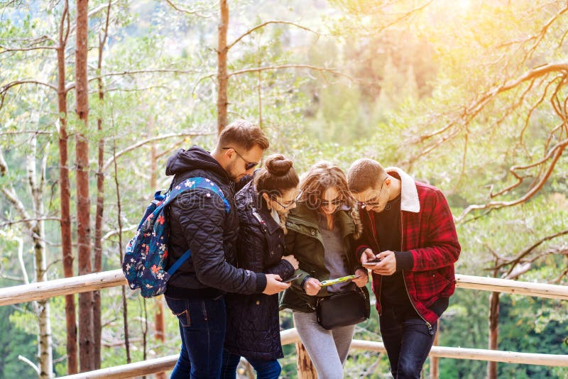 Four Tourists Trying To Find the Way Stock Photo - Image of people ...