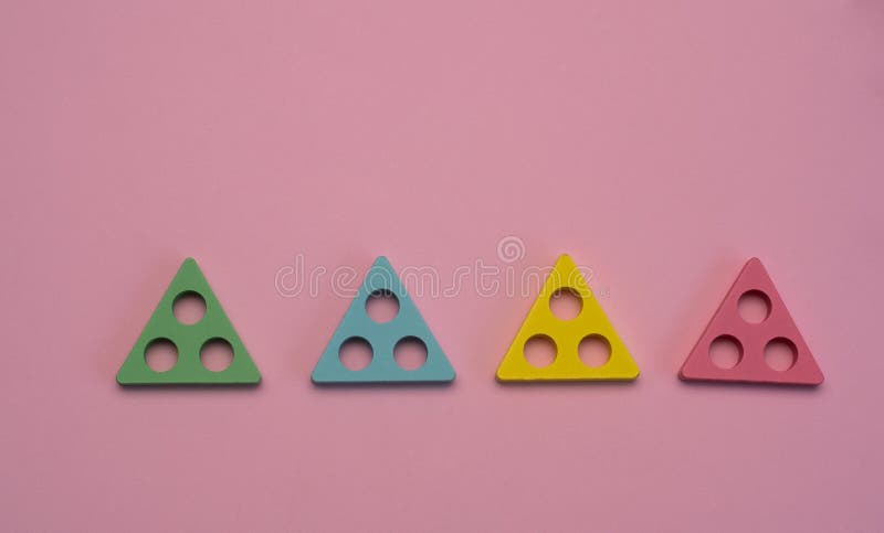 Four Triangles of Different Colors on a Pink Background. the Concept ...