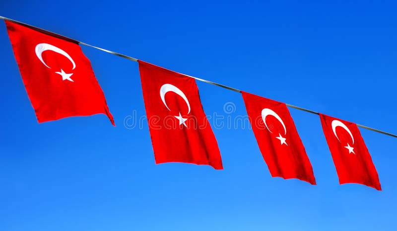 Four Turkish Flags Flying Against the Bright Blue Sky Stock Image ...